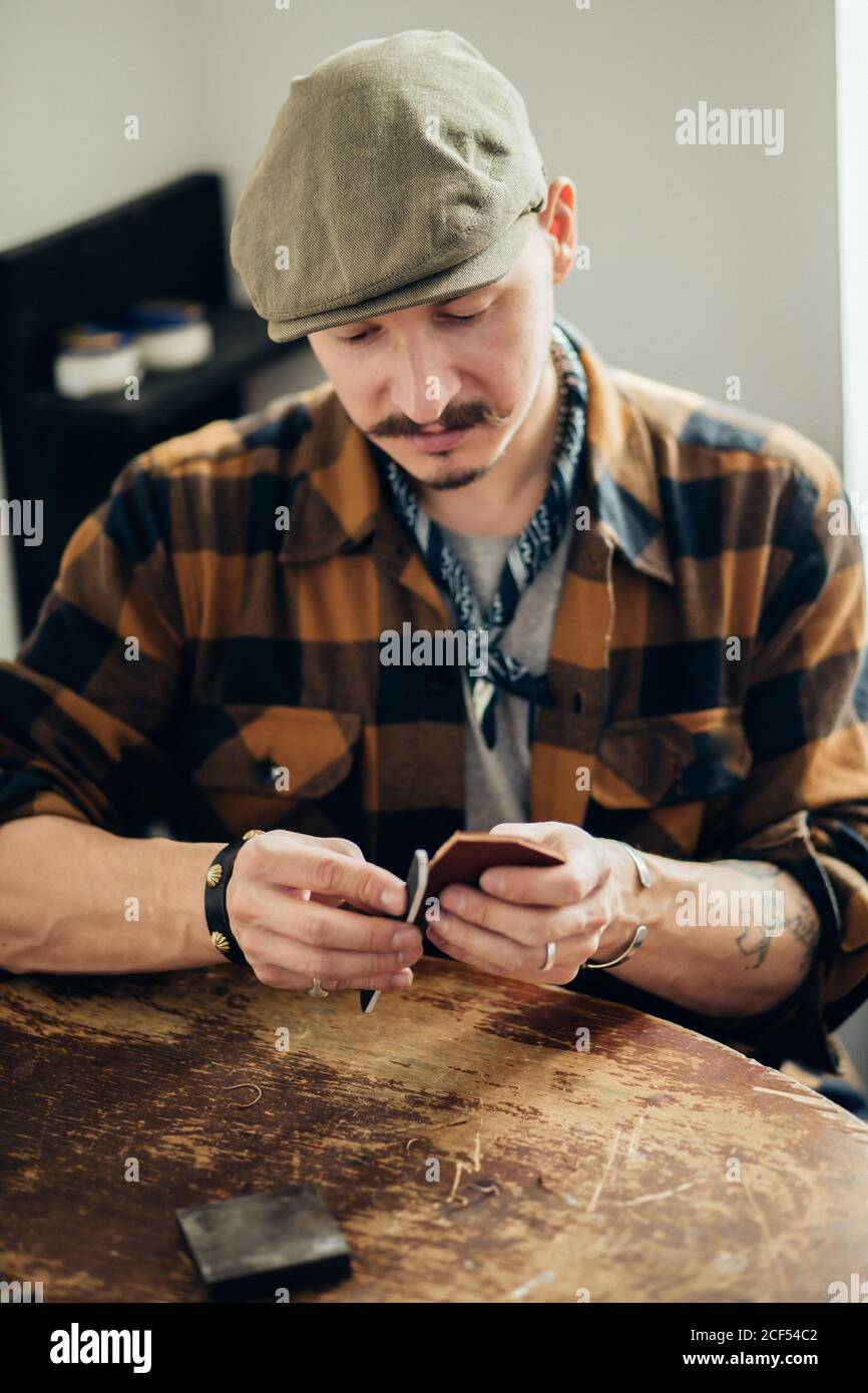 Professional crafter making leather items Stock Photo - Alamy