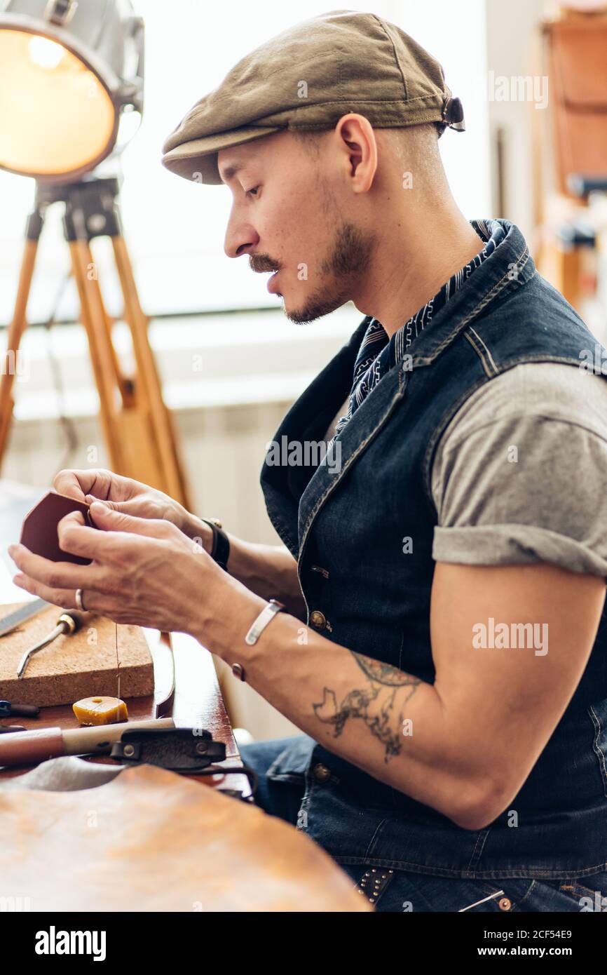 Professional crafter making leather items Stock Photo - Alamy