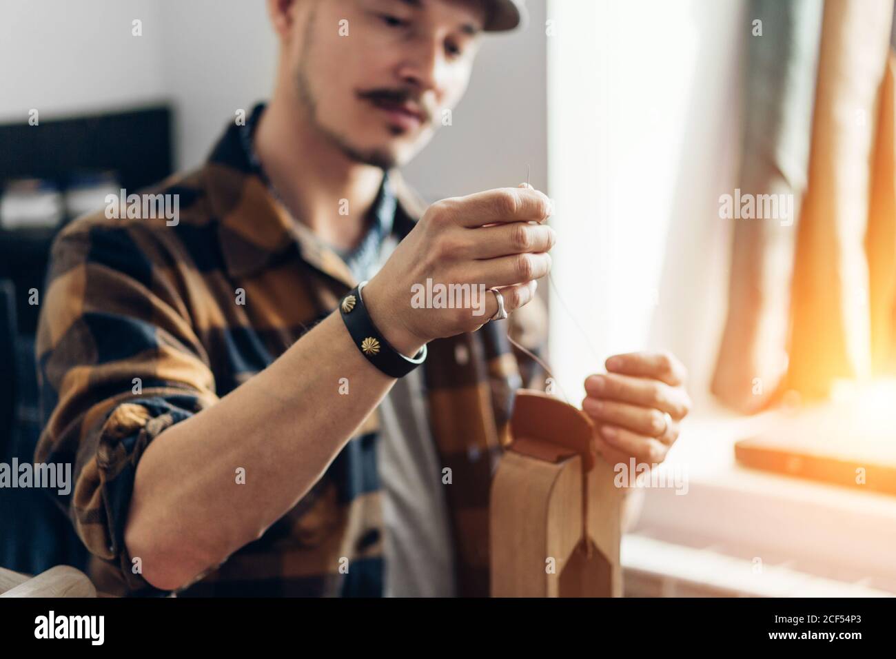 Professional crafter making leather items Stock Photo - Alamy