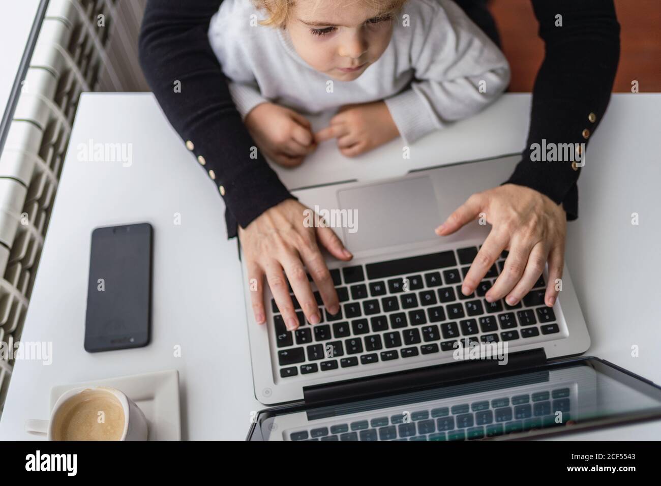 From above of crop anonymous female remote employee holding curious ...