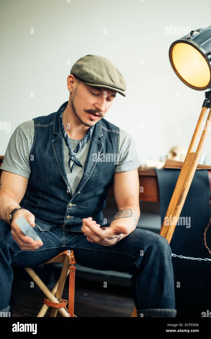 portrait of muscular middle eastern man wearing creative cup focused on ...
