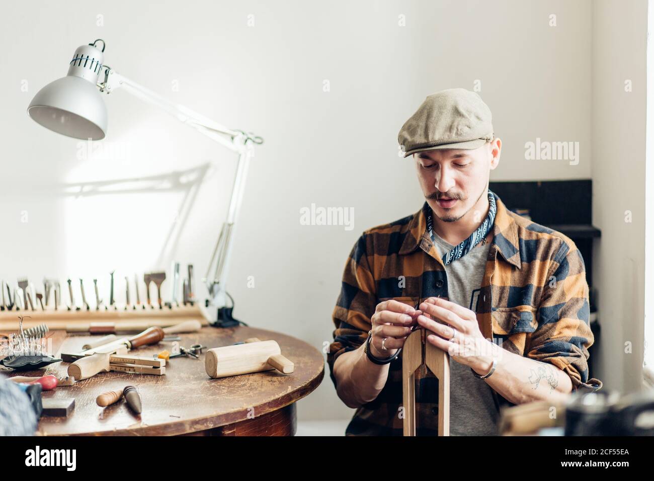 caucasian leather craft mustache man wearing cup working as artisan in ...
