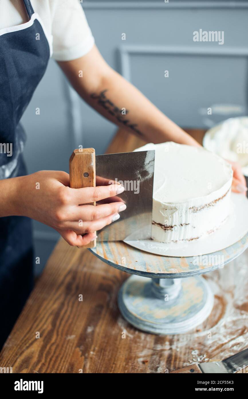 Woman Carefully Icing The Cake And Decorating Stock Photo - Alamy