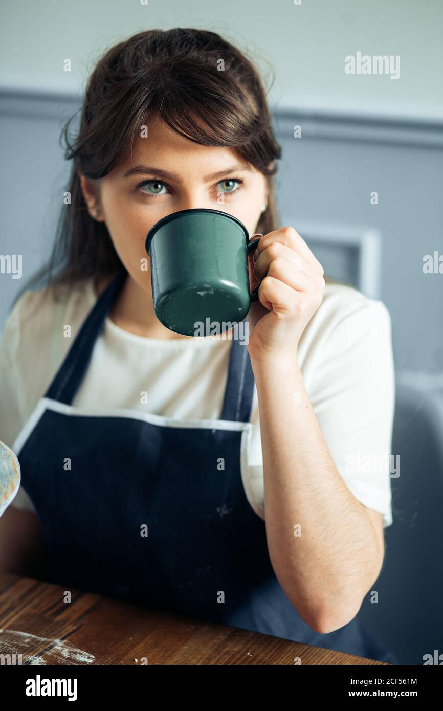 beautiful young woman sitting in a cafe drinking coffee Stock Photo - Alamy
