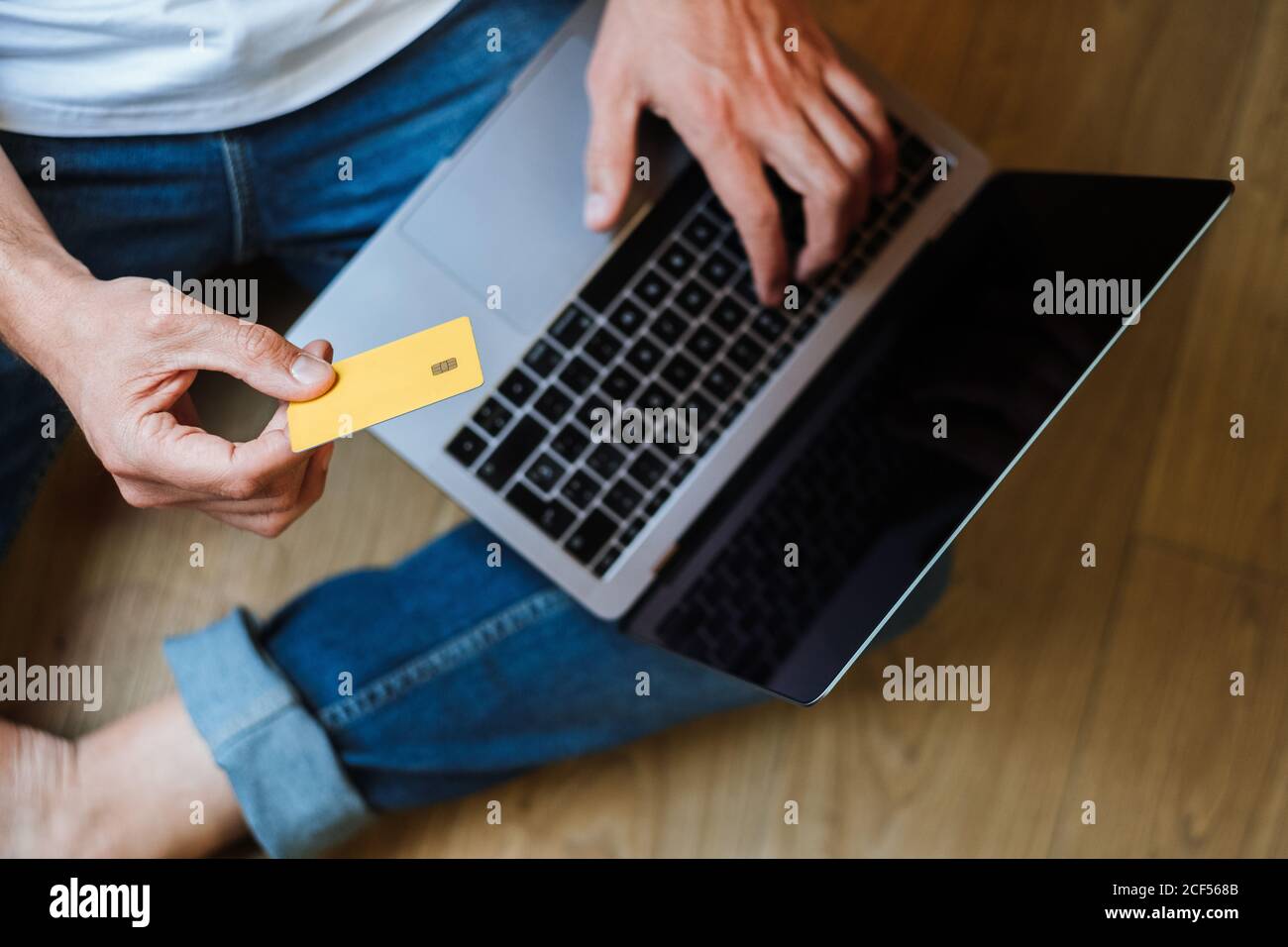 Crop man shopping online on floor Stock Photo - Alamy