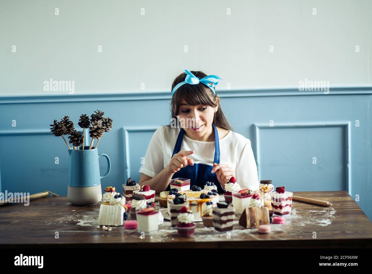 Young woman girl secretly eating cake Stock Photo - Alamy