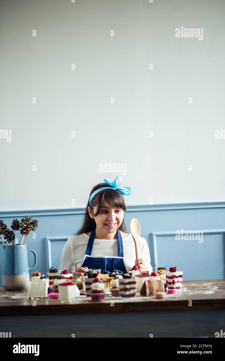 Young woman girl secretly eating cake Stock Photo - Alamy