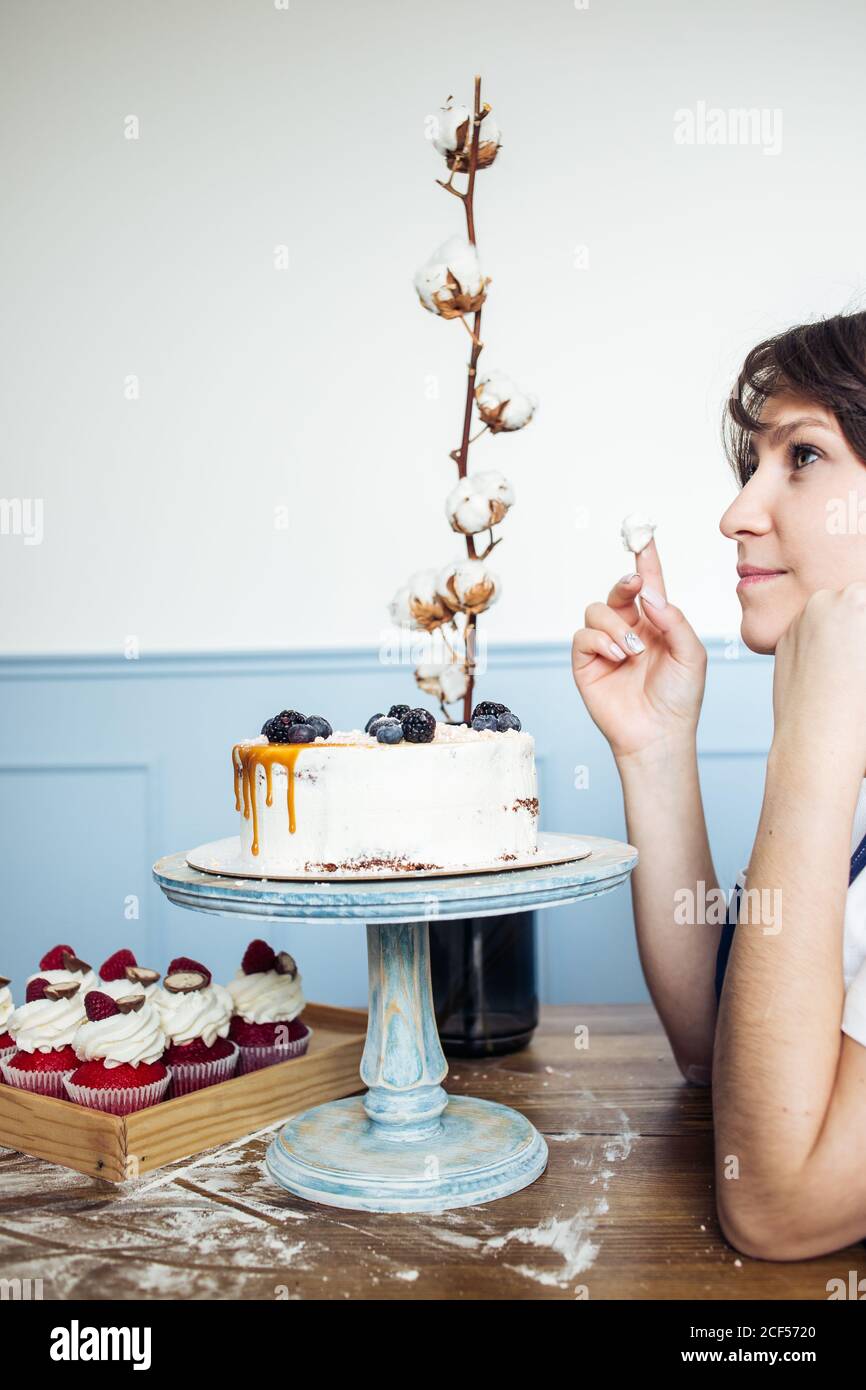 Young woman girl secretly eating cake Stock Photo - Alamy
