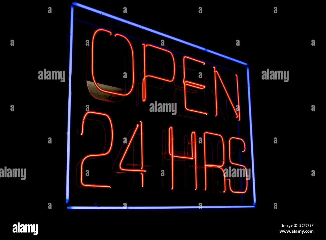 Inscription open 24 hrs in bright neon sign in dark in United States of ...