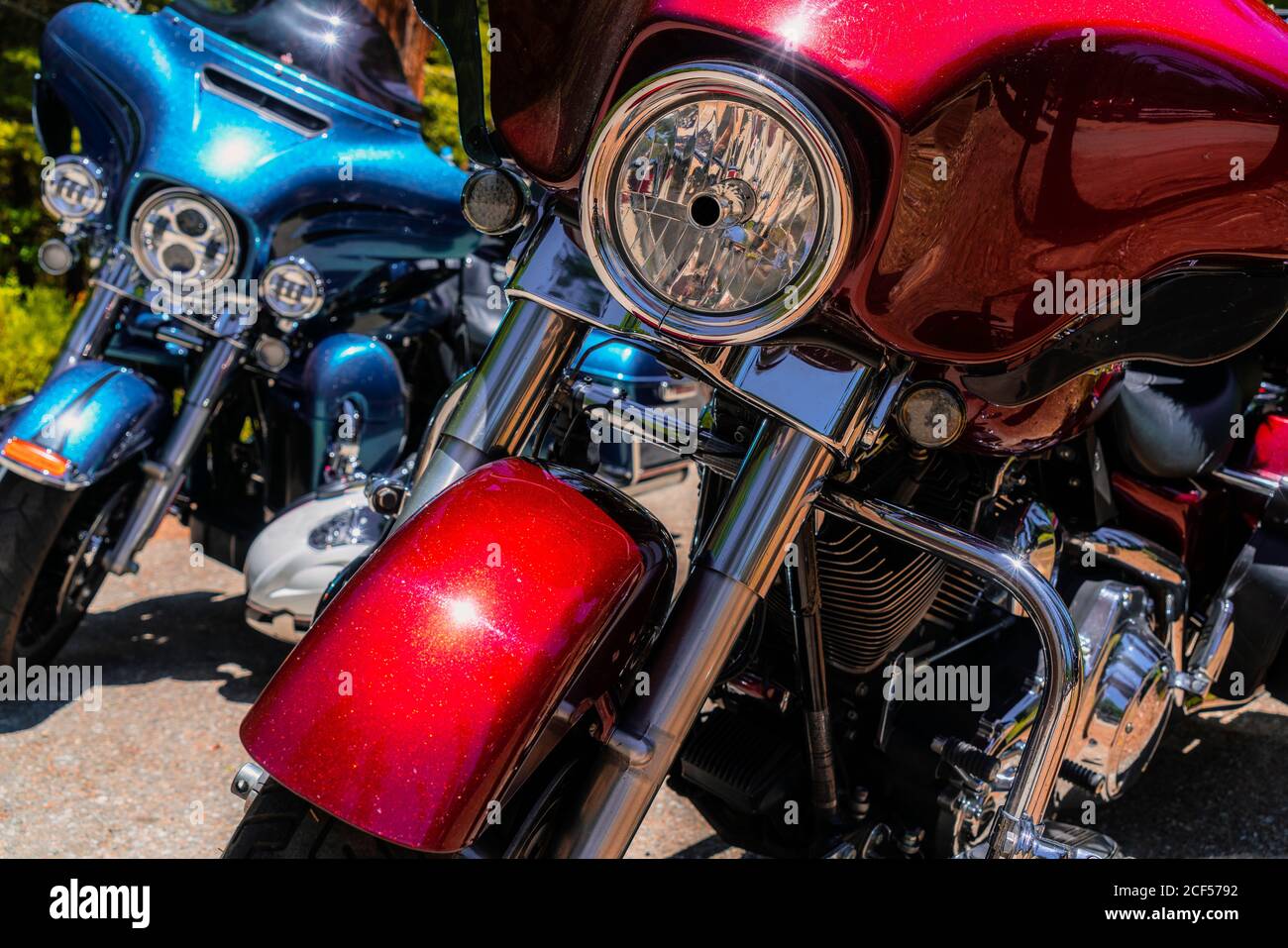 Red and blue front of motorcycles with headlights sparkling outdoors in ...