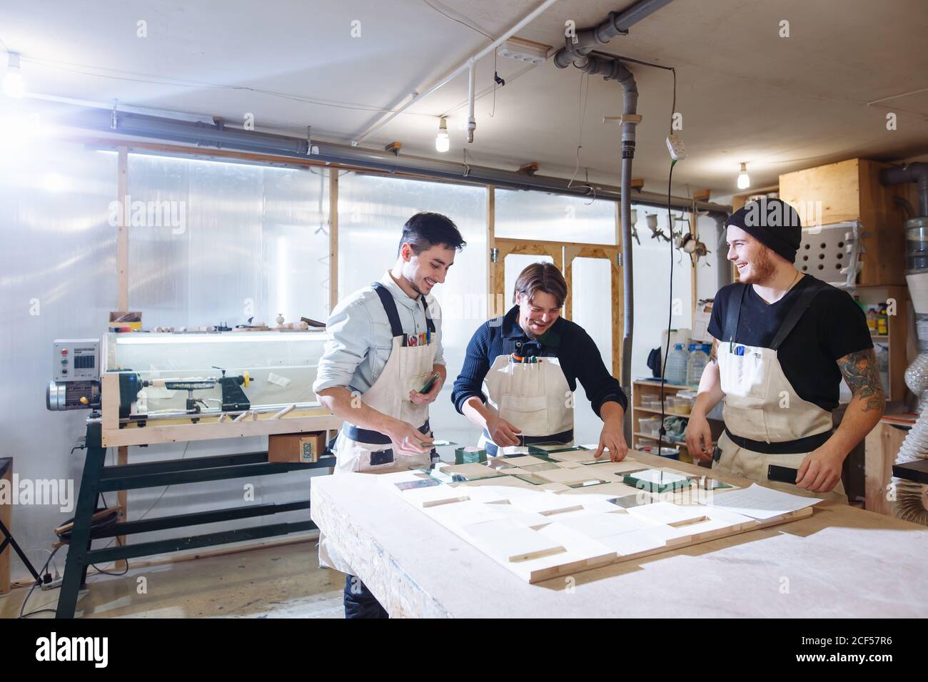Carpenter's workshop with a craftsman building a display case from wood ...