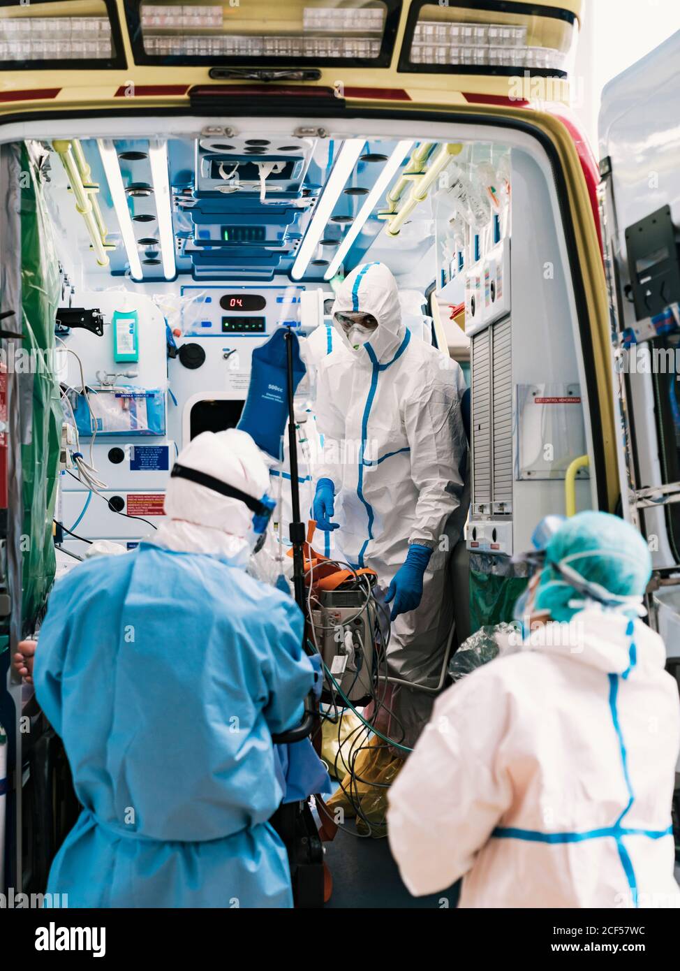 Group of professional doctors in protective uniform standing in ...