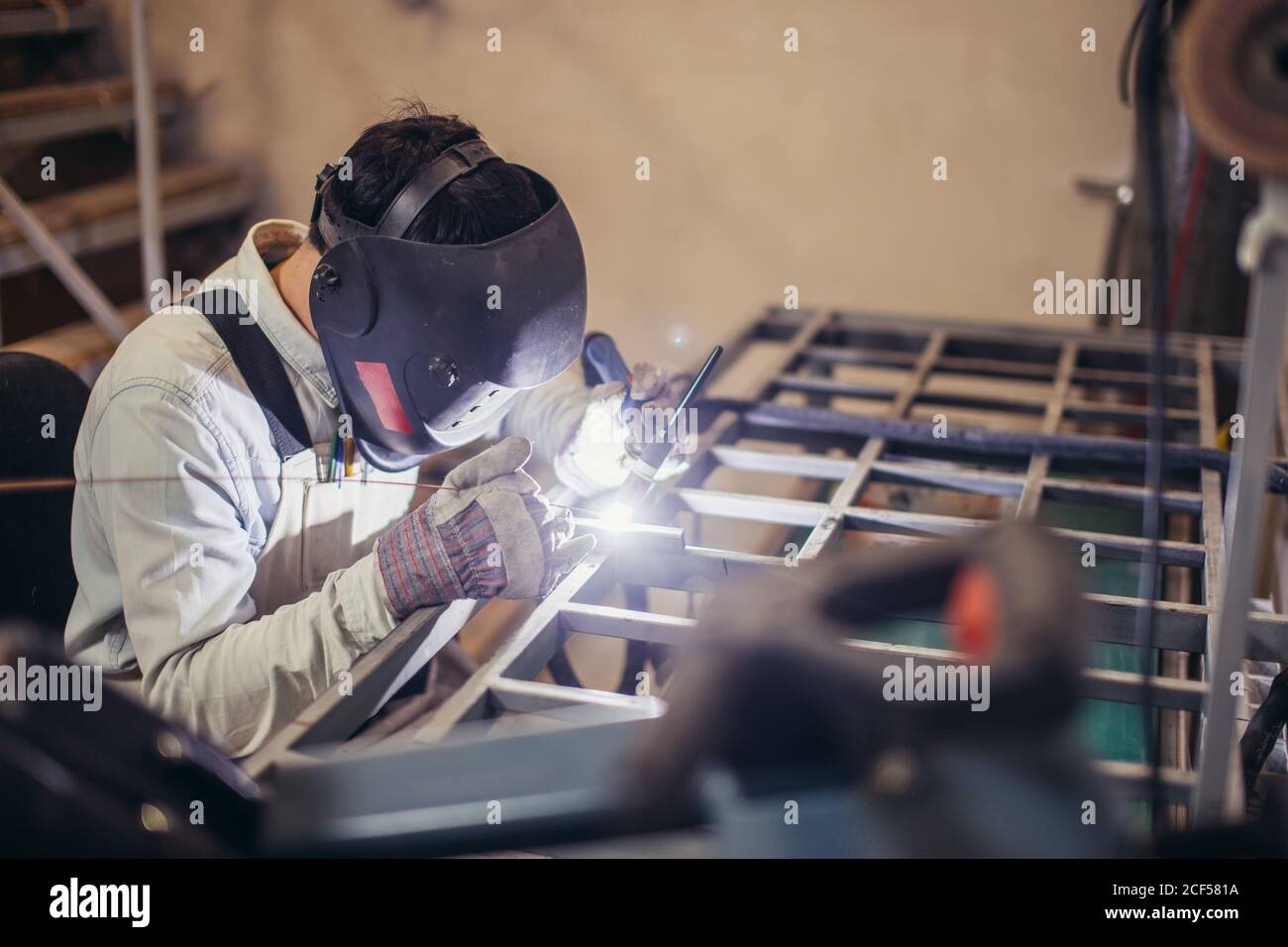 Industrial Worker labourer at the factory welding steel structure Stock ...
