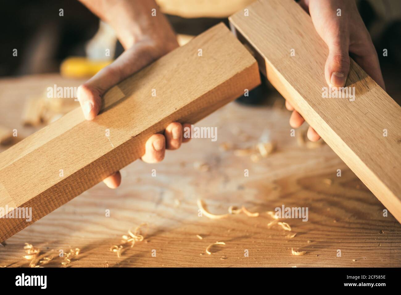 Man joining two parts of wooden planks. Worker carpenter joiner Stock ...
