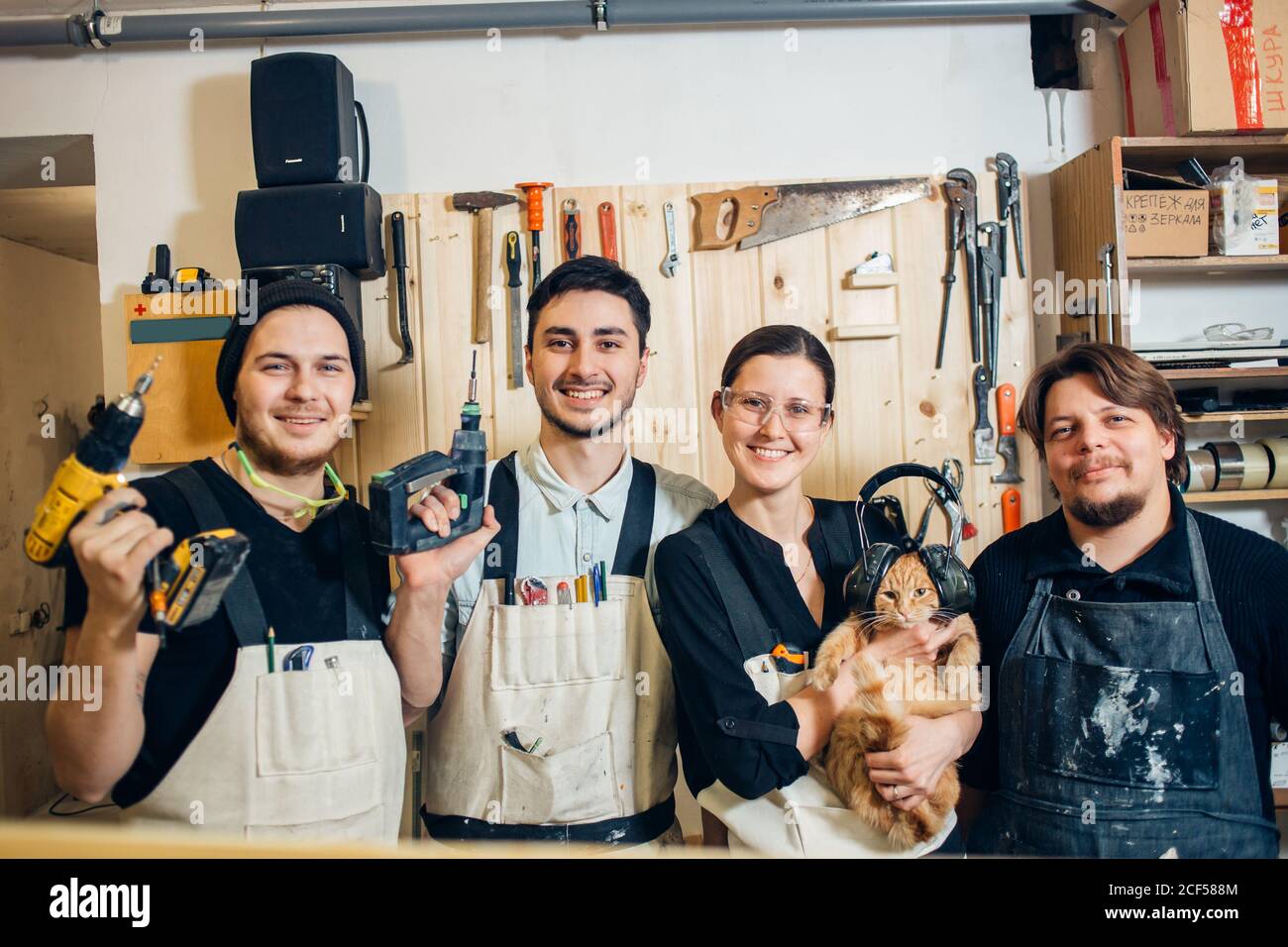 Group of carpenters with cat together as a group with arms crossed ...