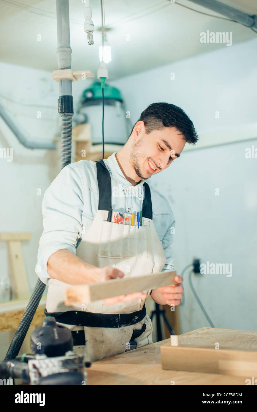 Man joining two parts of wooden planks. Worker carpenter joiner Stock ...