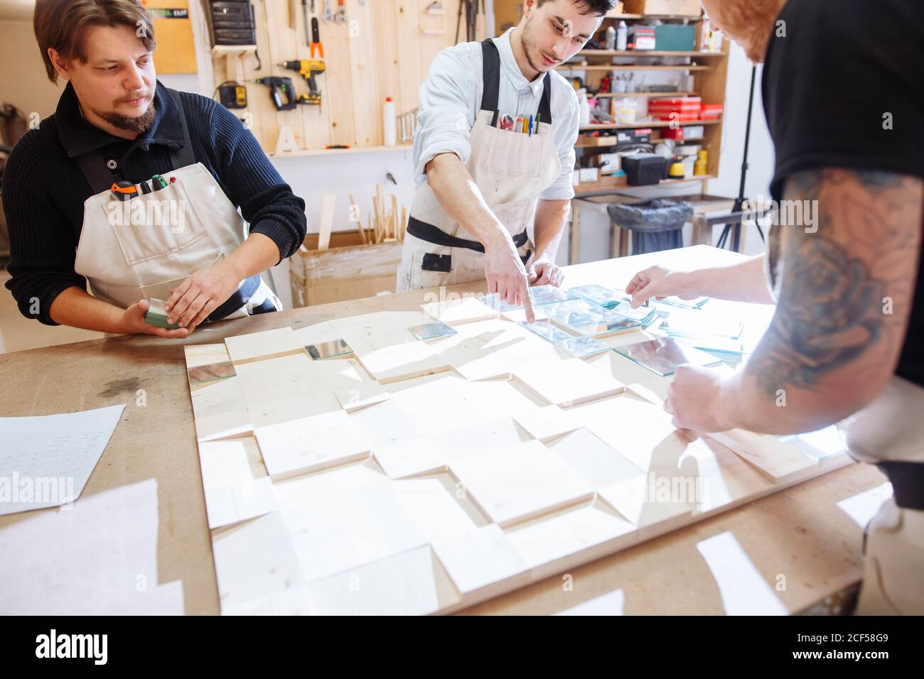 Carpenter's workshop with a craftsman building a display case from wood ...