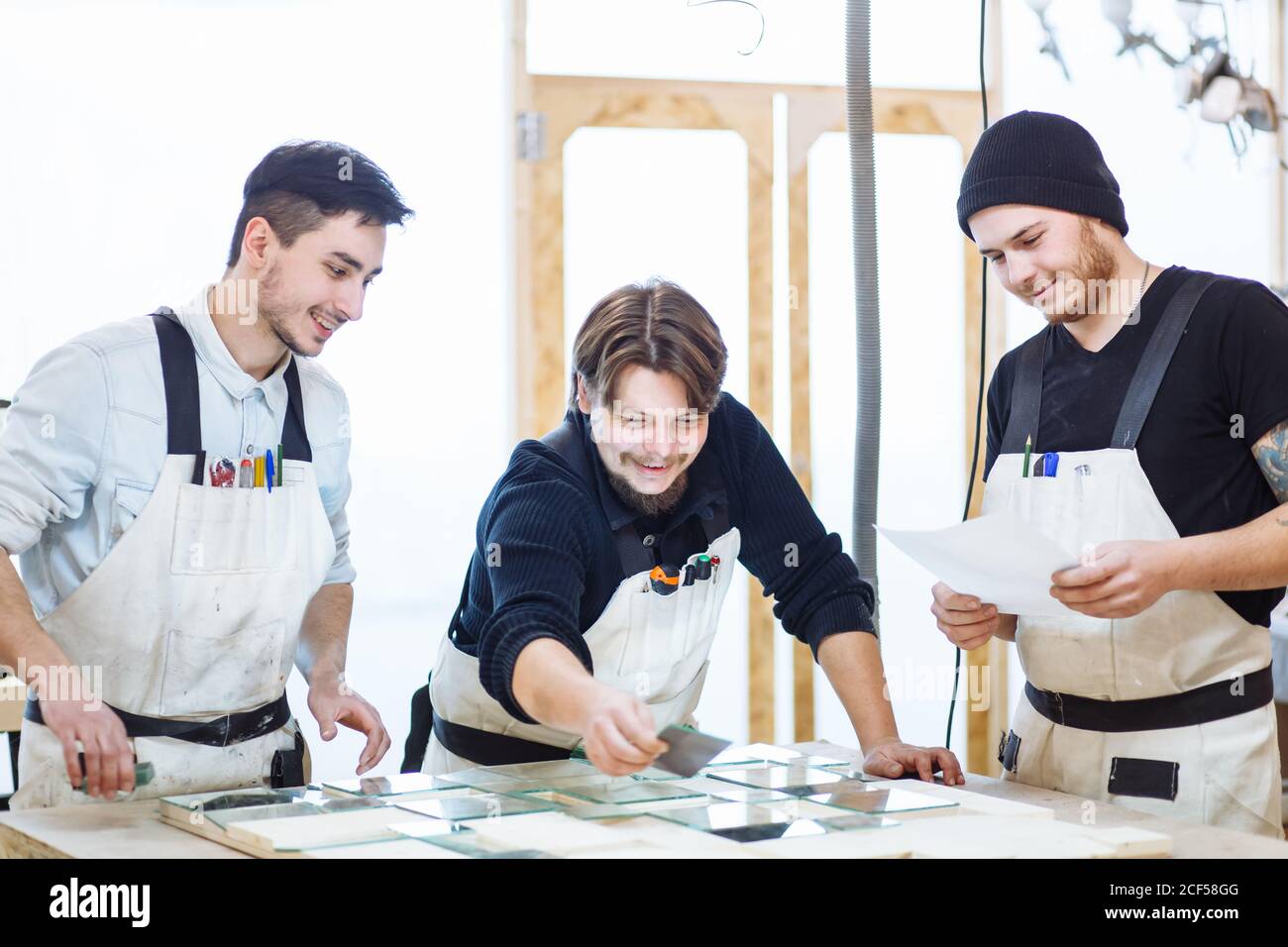 Carpenter's workshop with a craftsman building a display case from wood ...