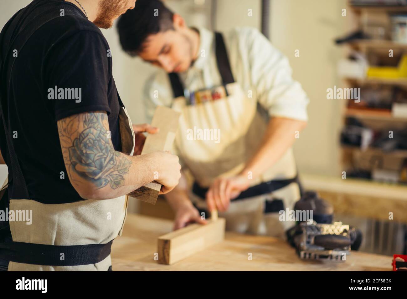 Man joining two parts of wooden planks. Worker carpenter joiner Stock ...