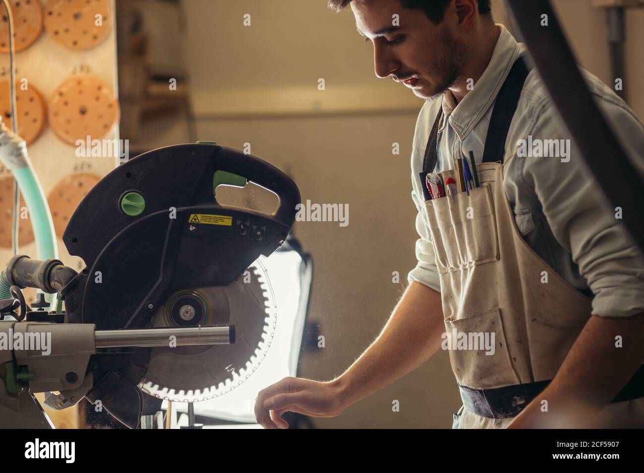 Man using miter saw to cut wood hi-res stock photography and images - Alamy