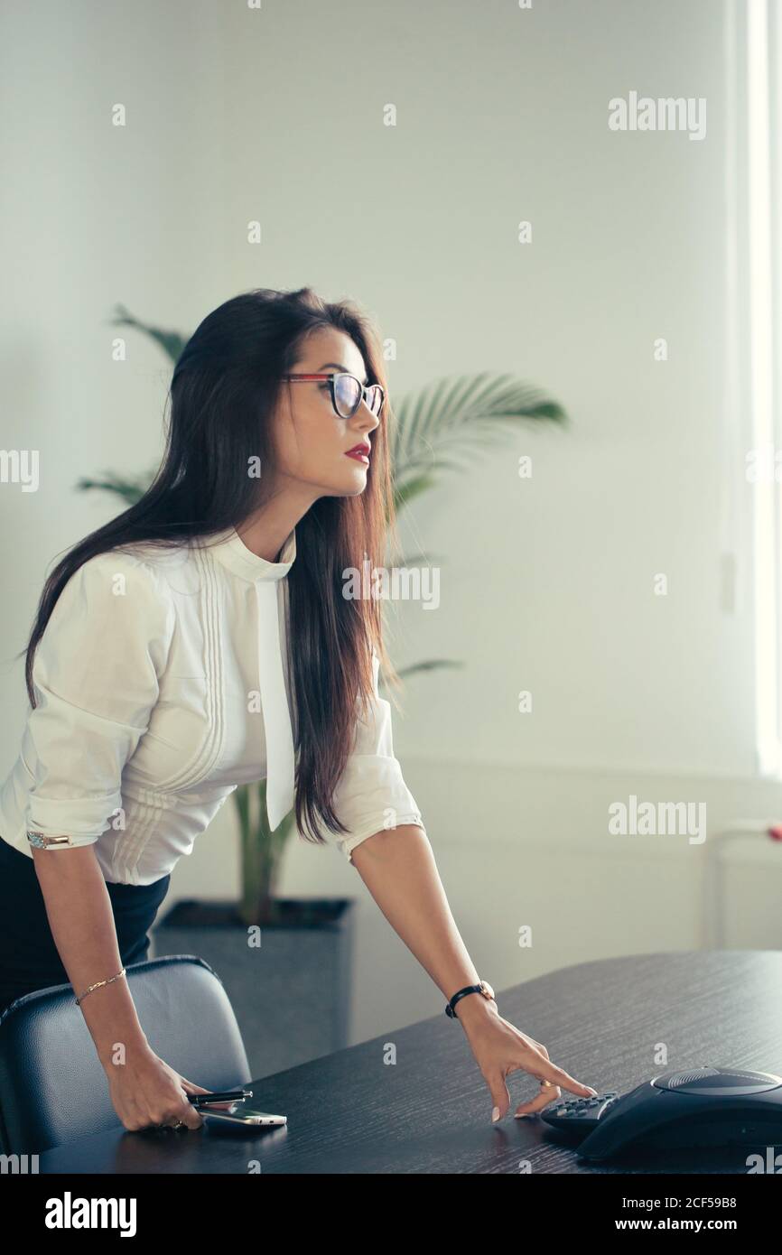 woman using IP Phone for conference in office Stock Photo - Alamy