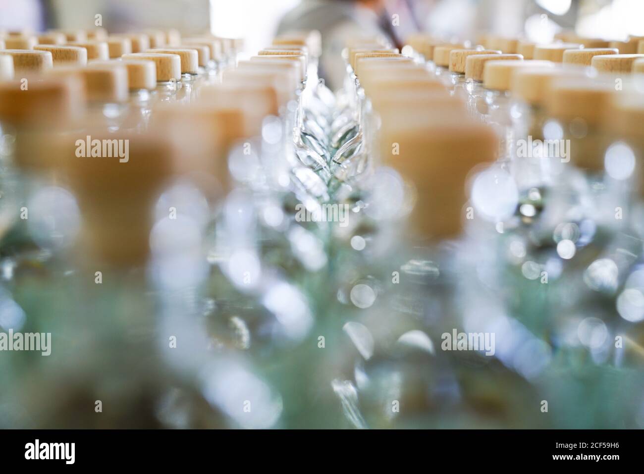 Blurred lines of glass bottles with lids in daylight Stock Photo - Alamy