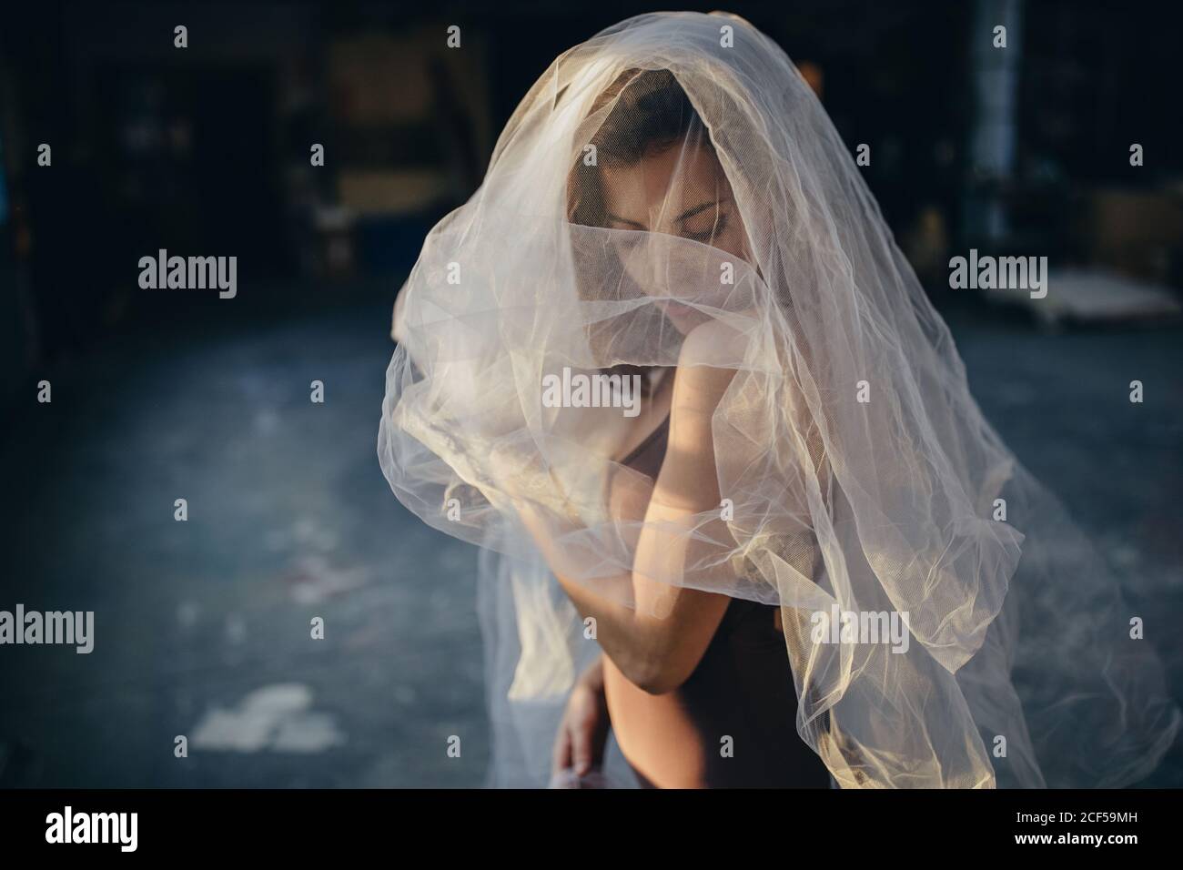Young talented female dancer with closed eyes in bodysuit dancing with ...