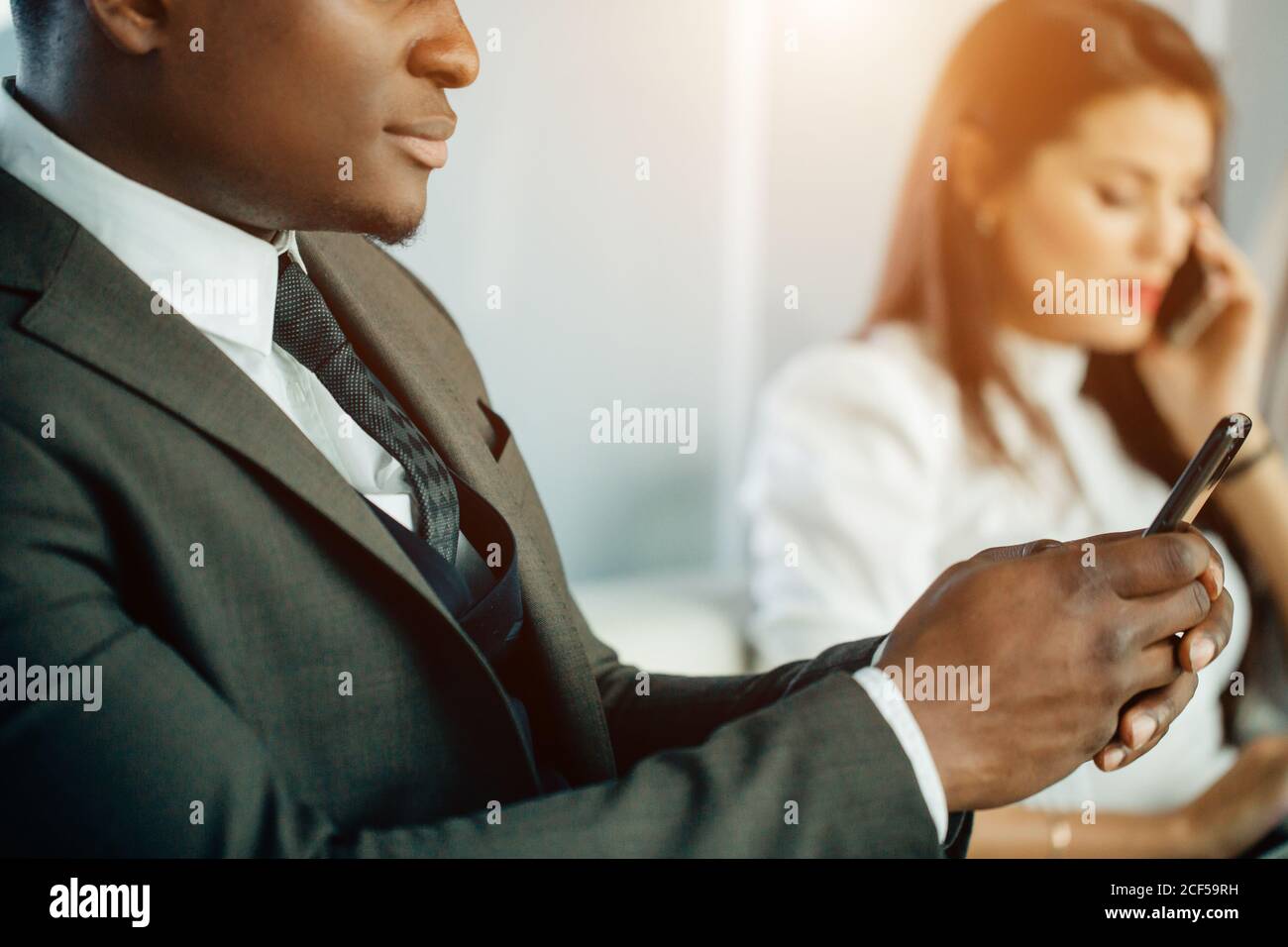 Group of young people use their phones in meeting Stock Photo - Alamy