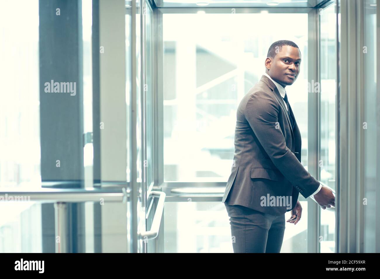 Confident black business man in a stylish suit standing in Elevator ...