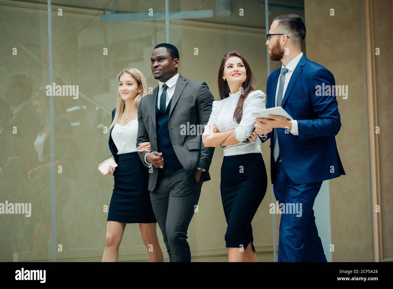 Quick briefing before meeting. four cheerful young business people ...