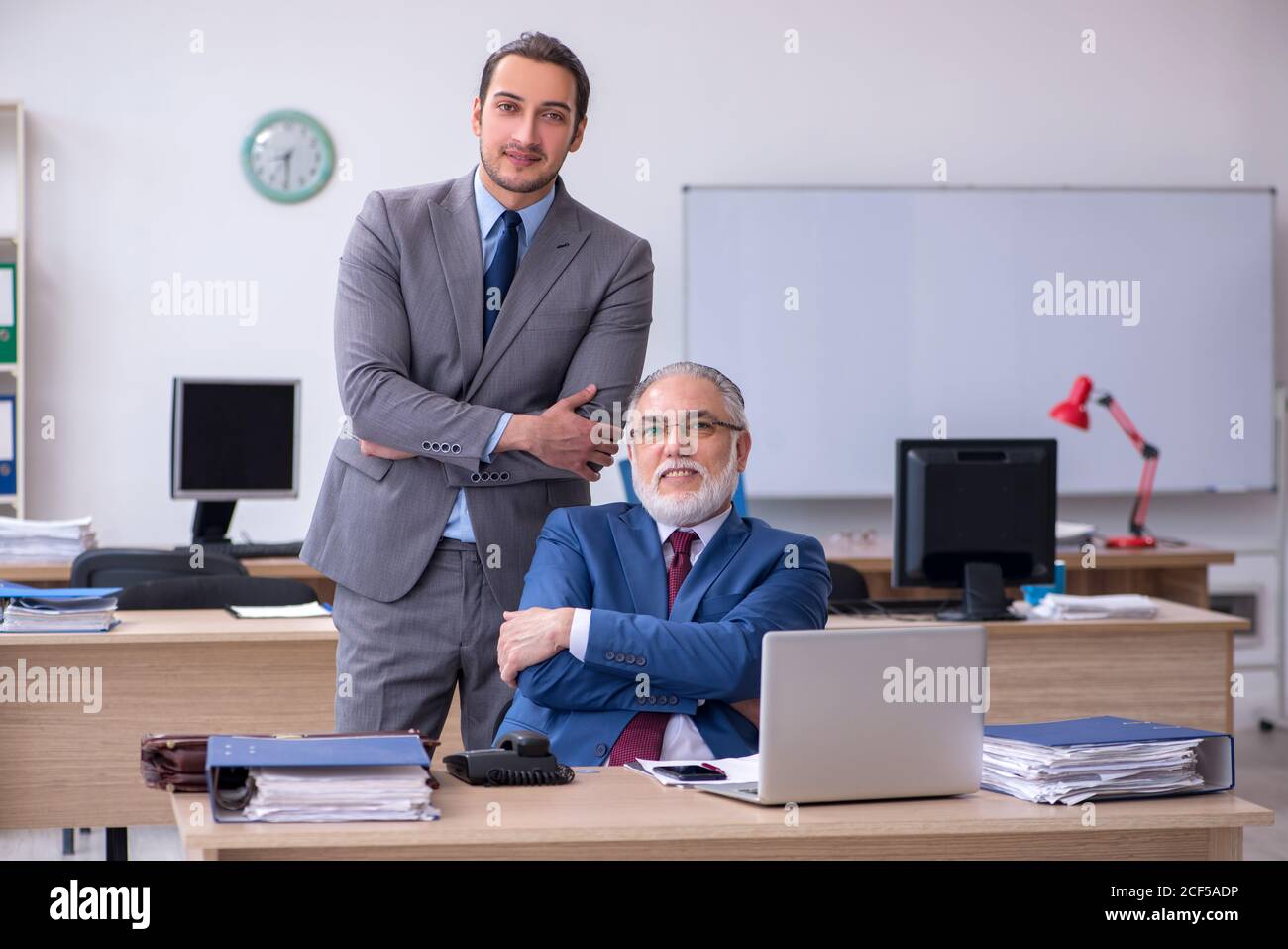 Two employees working in the office Stock Photo - Alamy