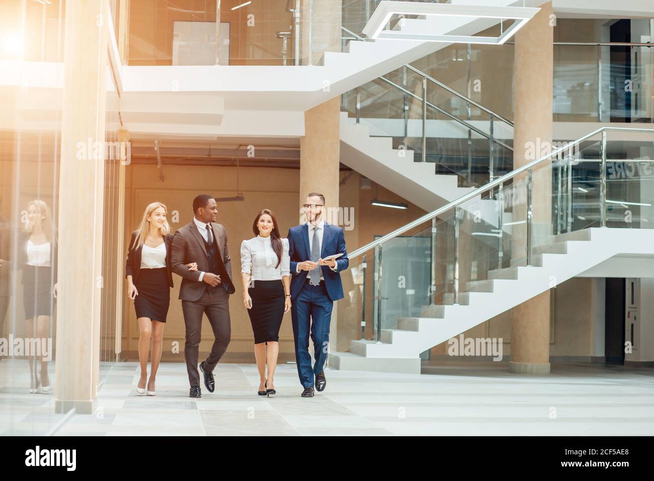 Quick briefing before meeting. four cheerful young business people ...