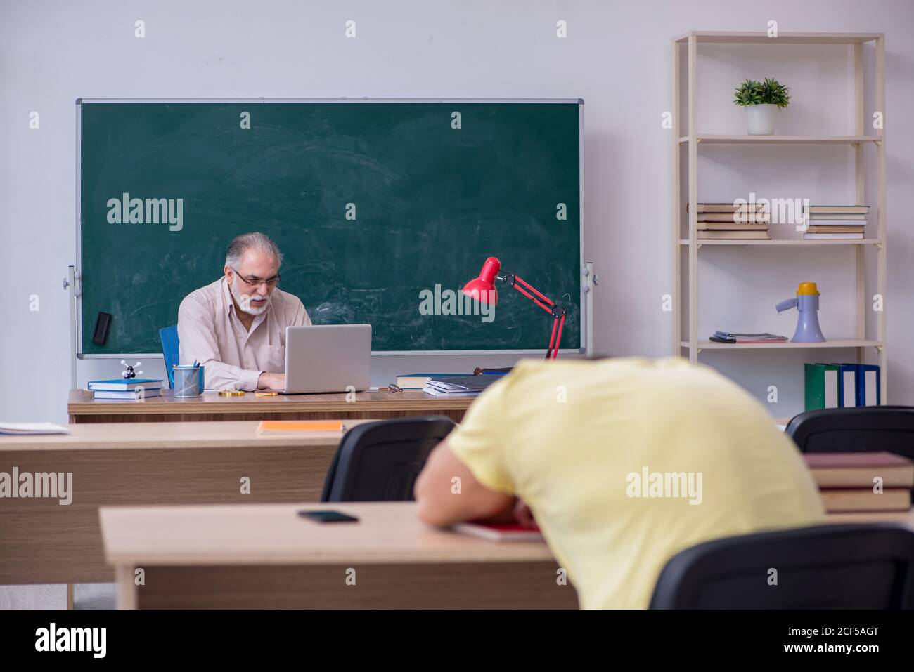 Old teacher and young student in the classroom Stock Photo - Alamy