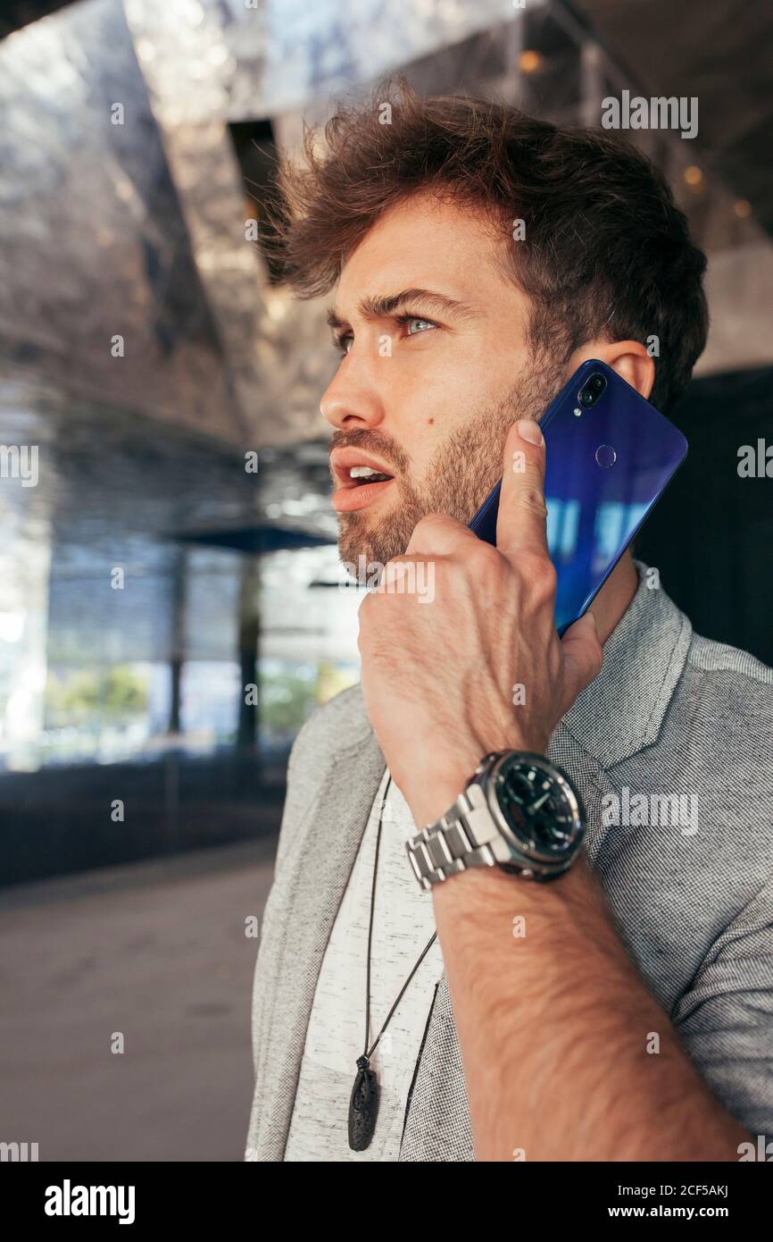 Serious guy calling phone park hi-res stock photography and images - Alamy