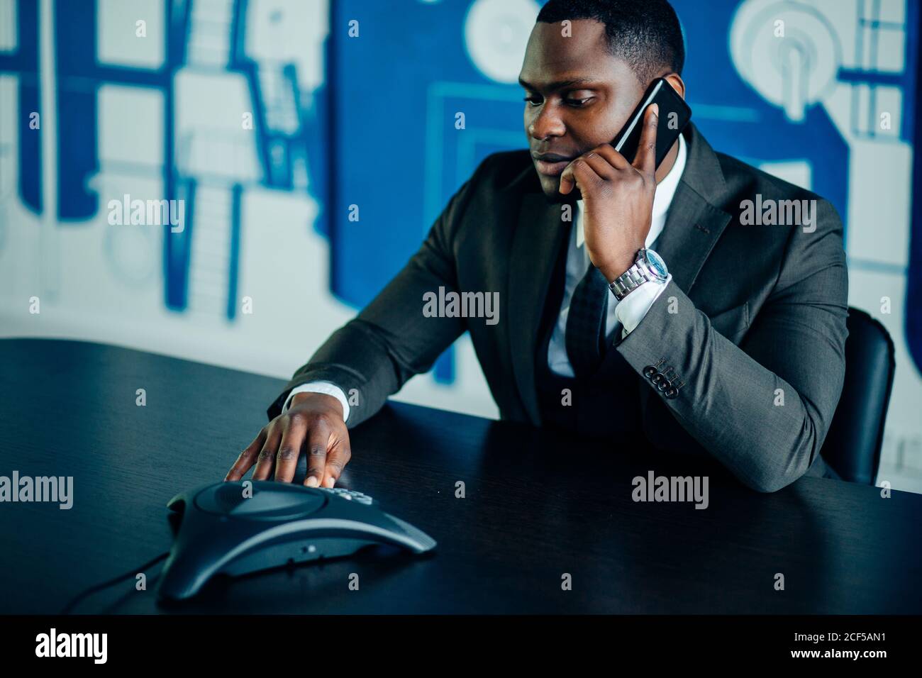 Teleconference - business people hand dialing a number on a modern ...