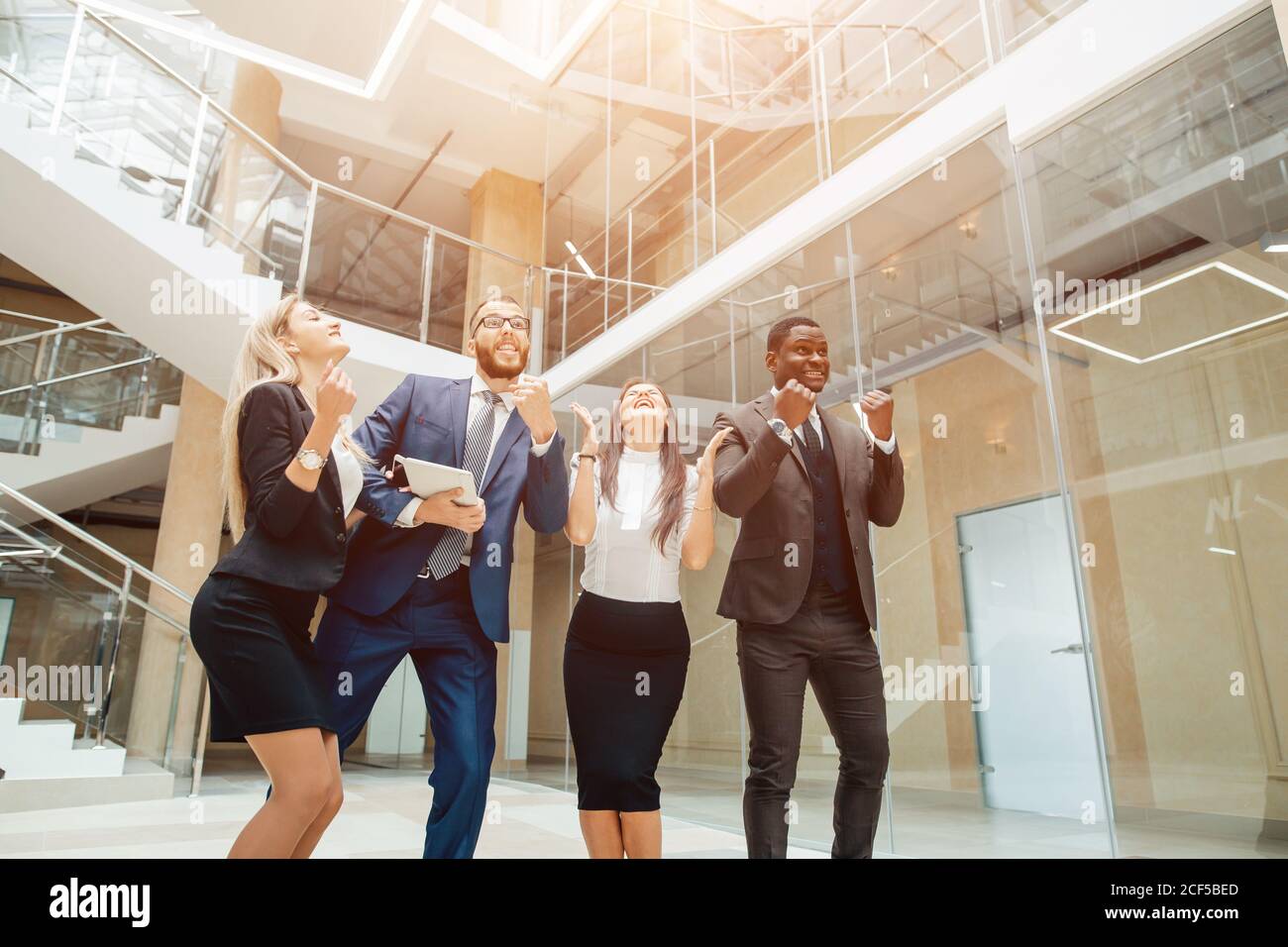 Happy business people celebrate success in the office. Successful ...