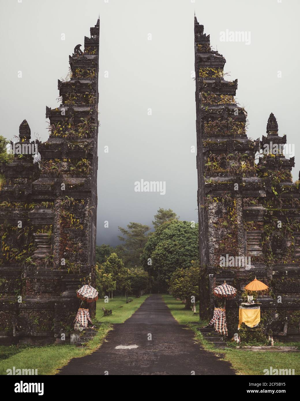 paved roadway into ancient mossy gates of temple, Bali Stock Photo - Alamy