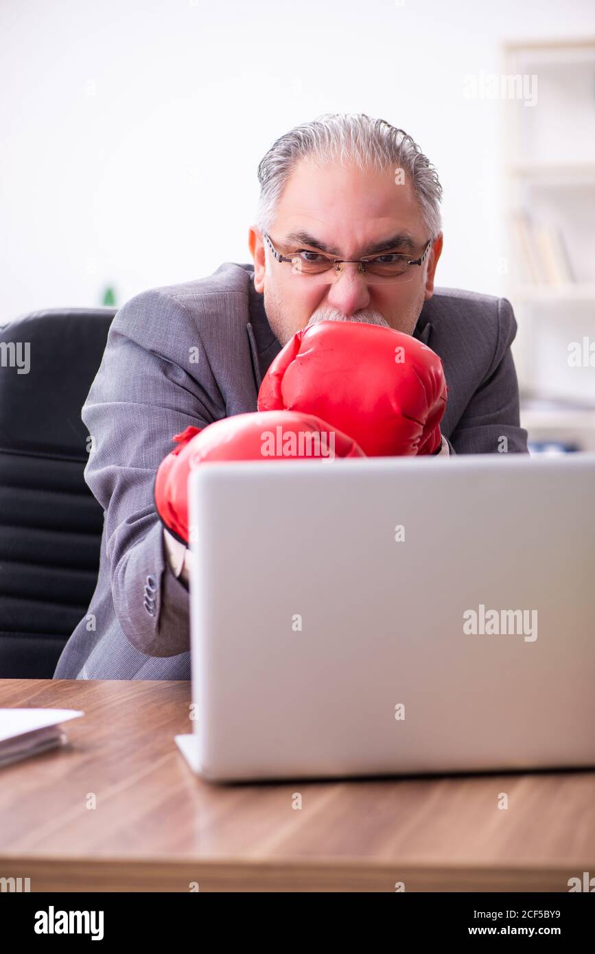 Businessman angry and furious at his workplace Stock Photo - Alamy