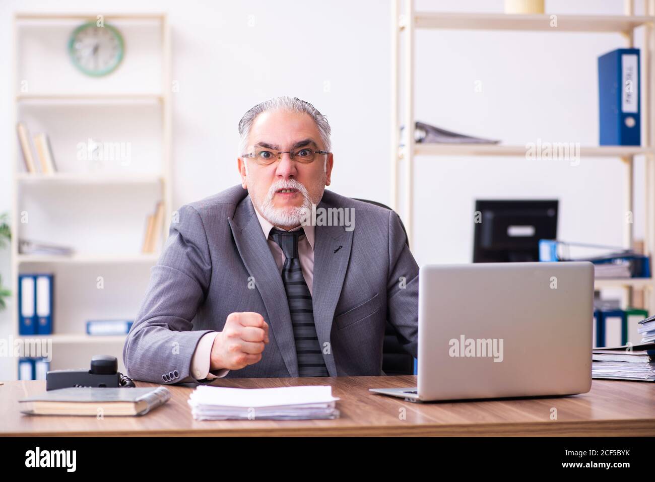 Businessman angry and furious at his workplace Stock Photo - Alamy