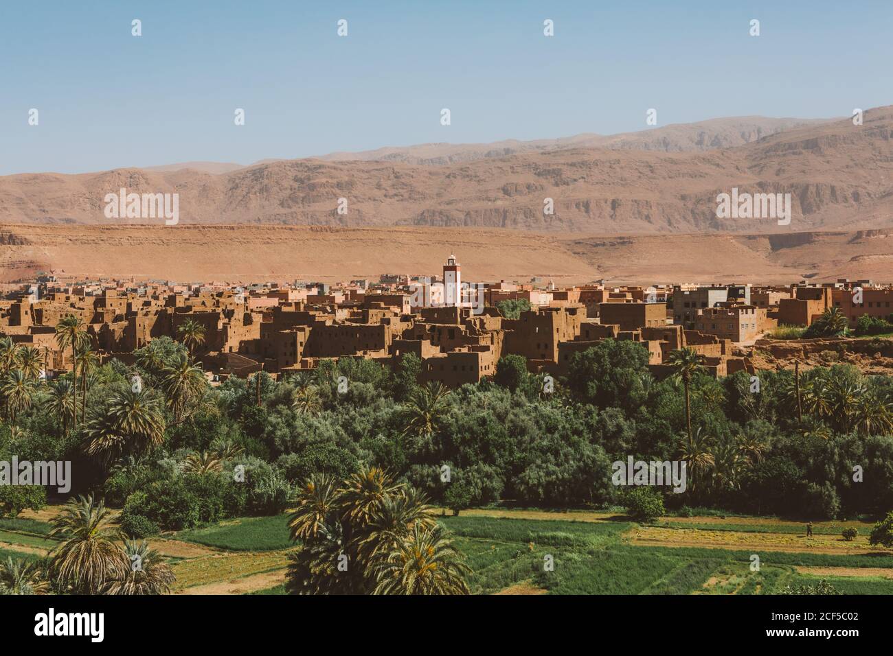 Picturesque view of green park and old city in desert land of Morocco ...