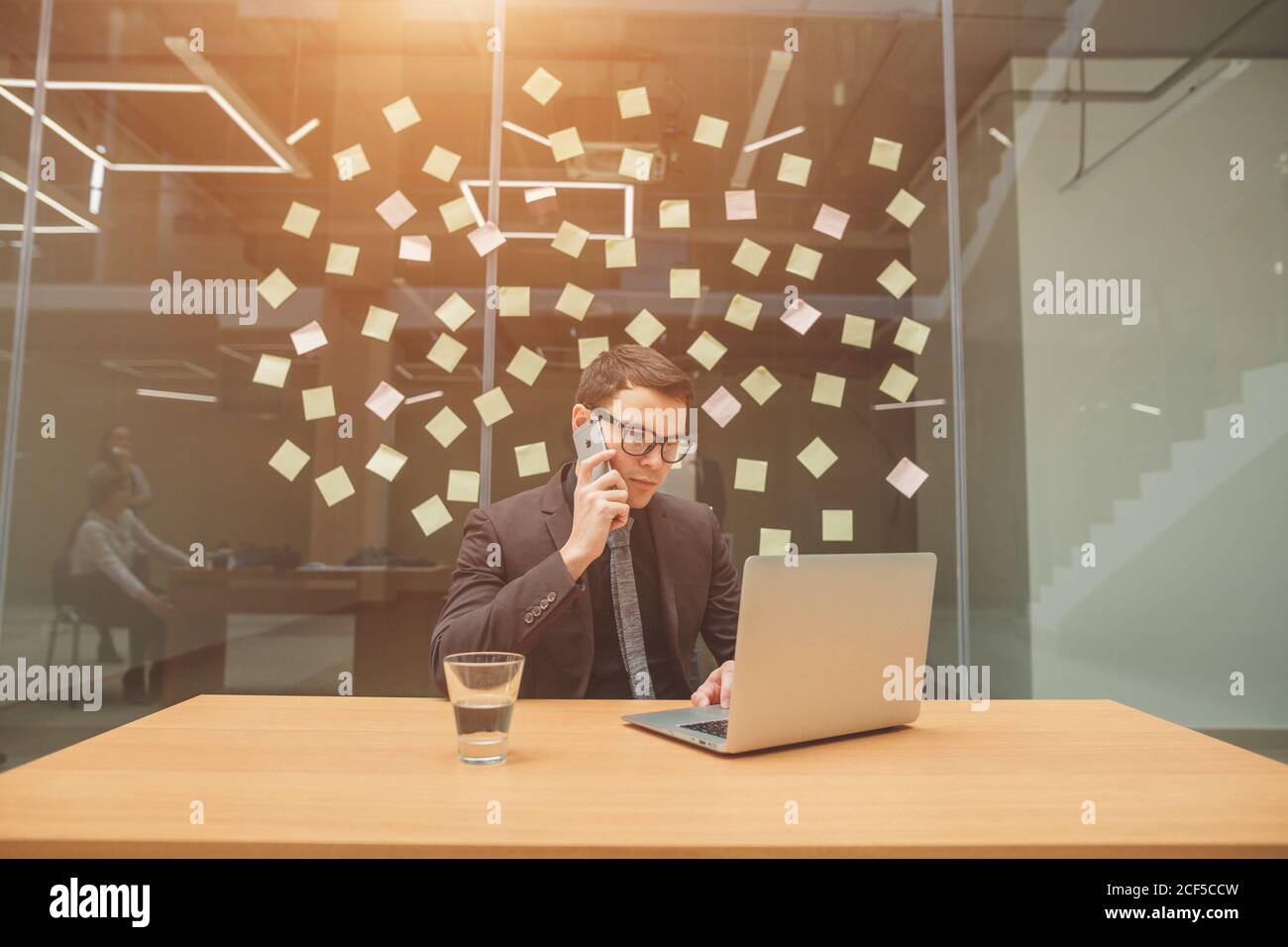 Business owner of a modern office checking his laptop Stock Photo - Alamy