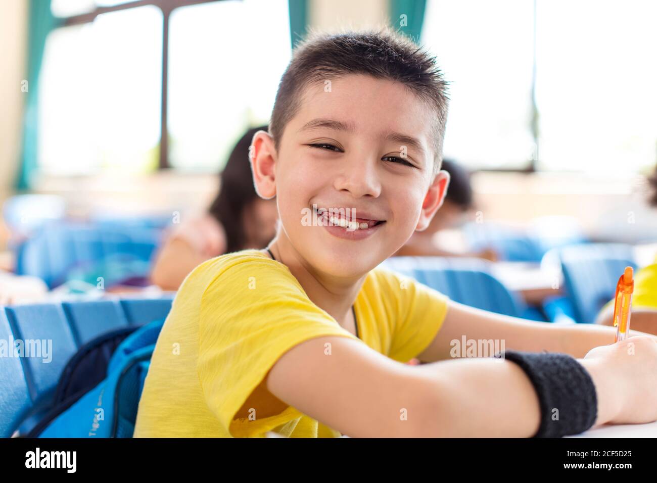 happy little boy studying in the classroom Stock Photo - Alamy