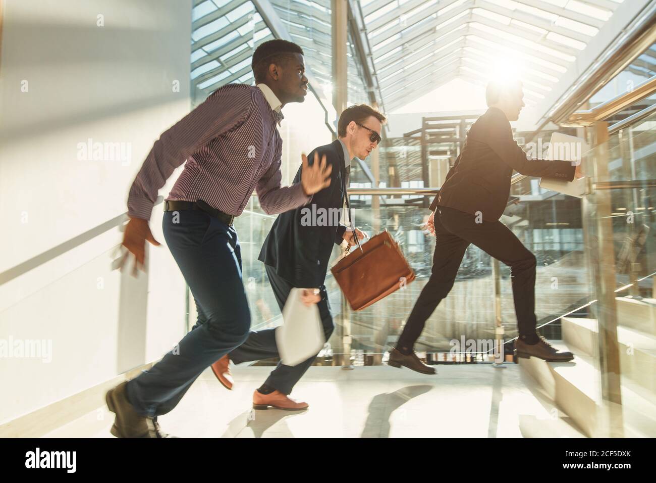 Lively business people running on steps. Concept of teamwork ...