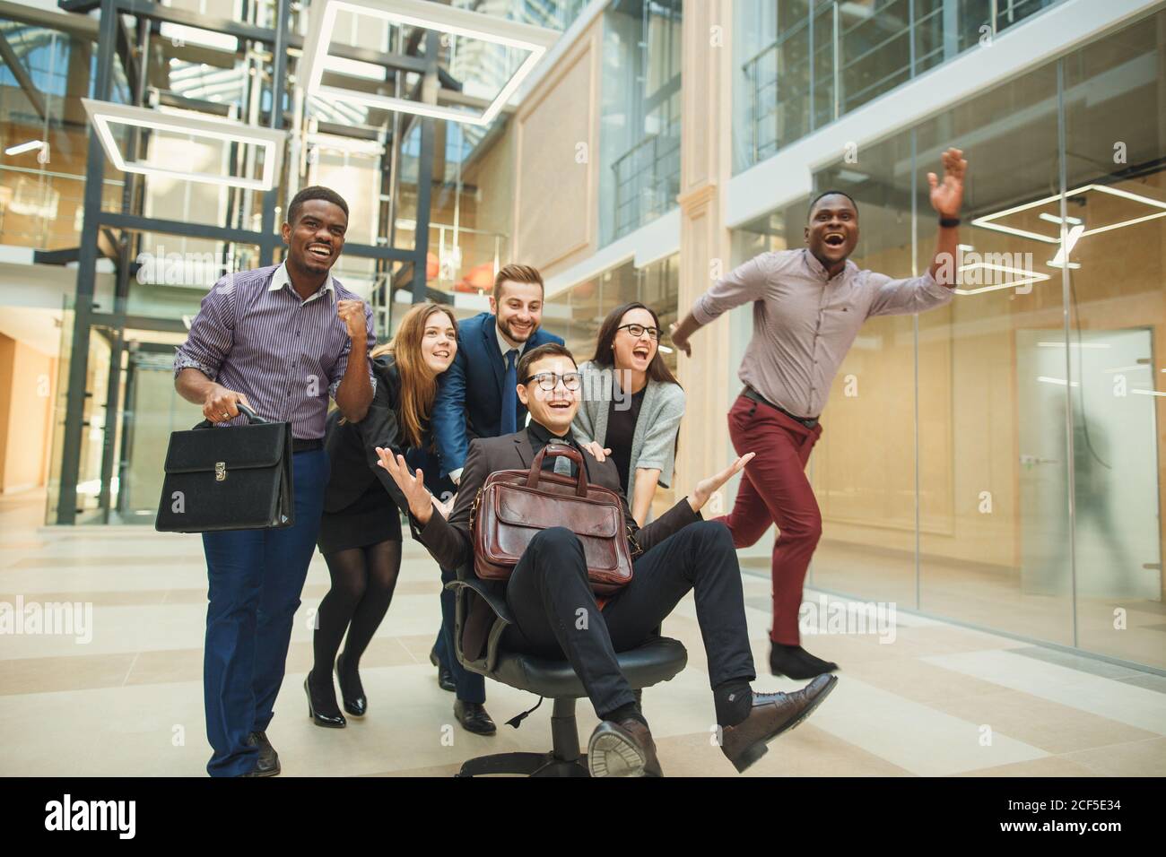 excited business people group team push colleague leader sitting in ...