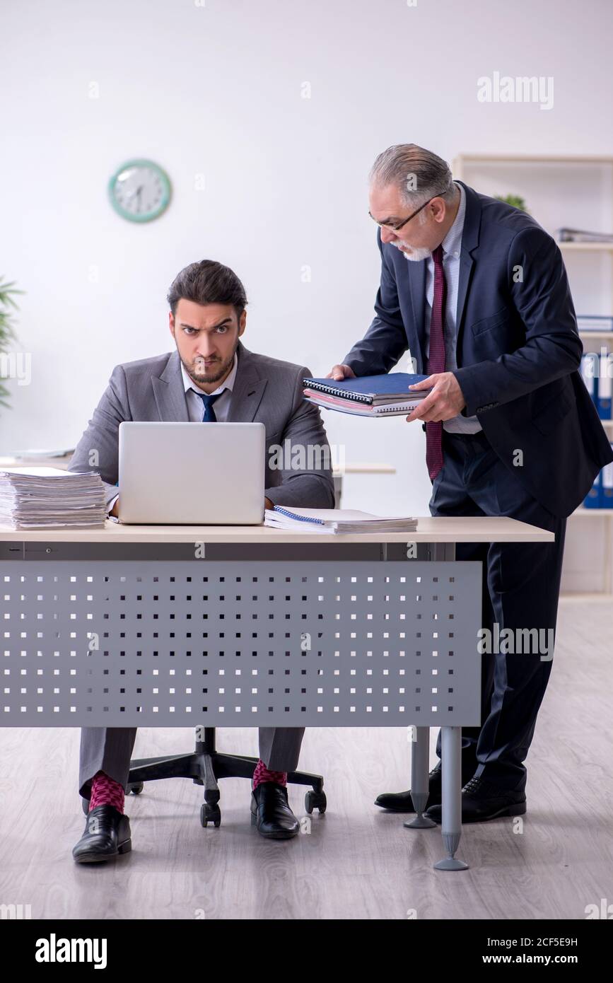 Old boss and his assistant working in the office Stock Photo - Alamy