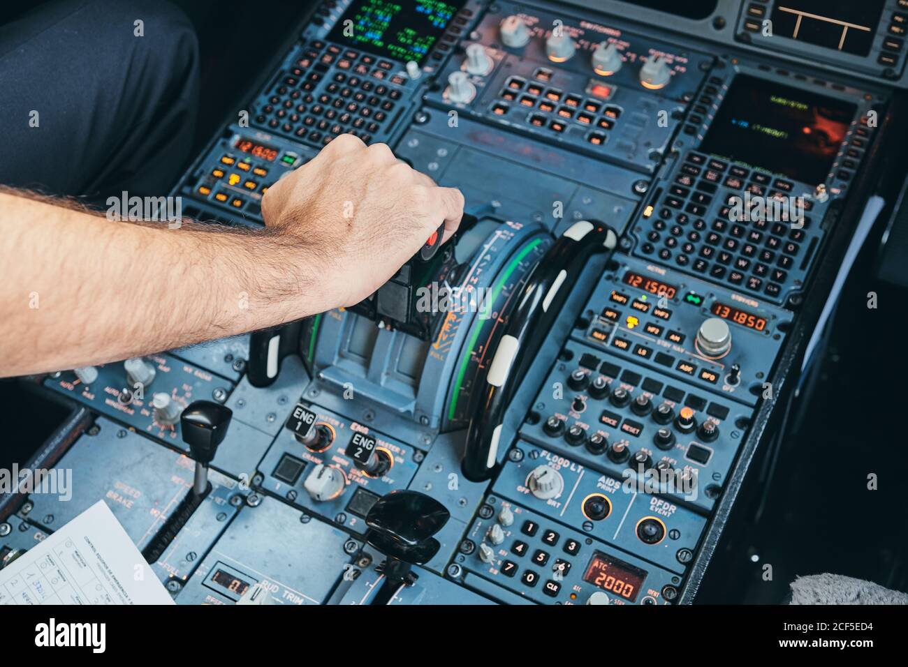 From above crop anonymous male aviator pushing lever on dashboard while ...