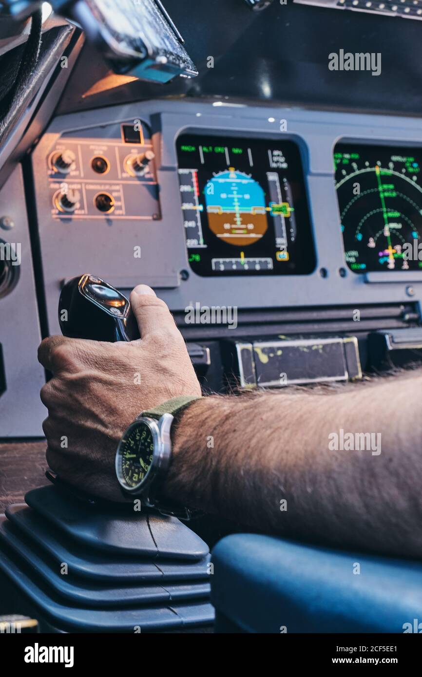 Pilot controlling airplane in cockpit Stock Photo - Alamy