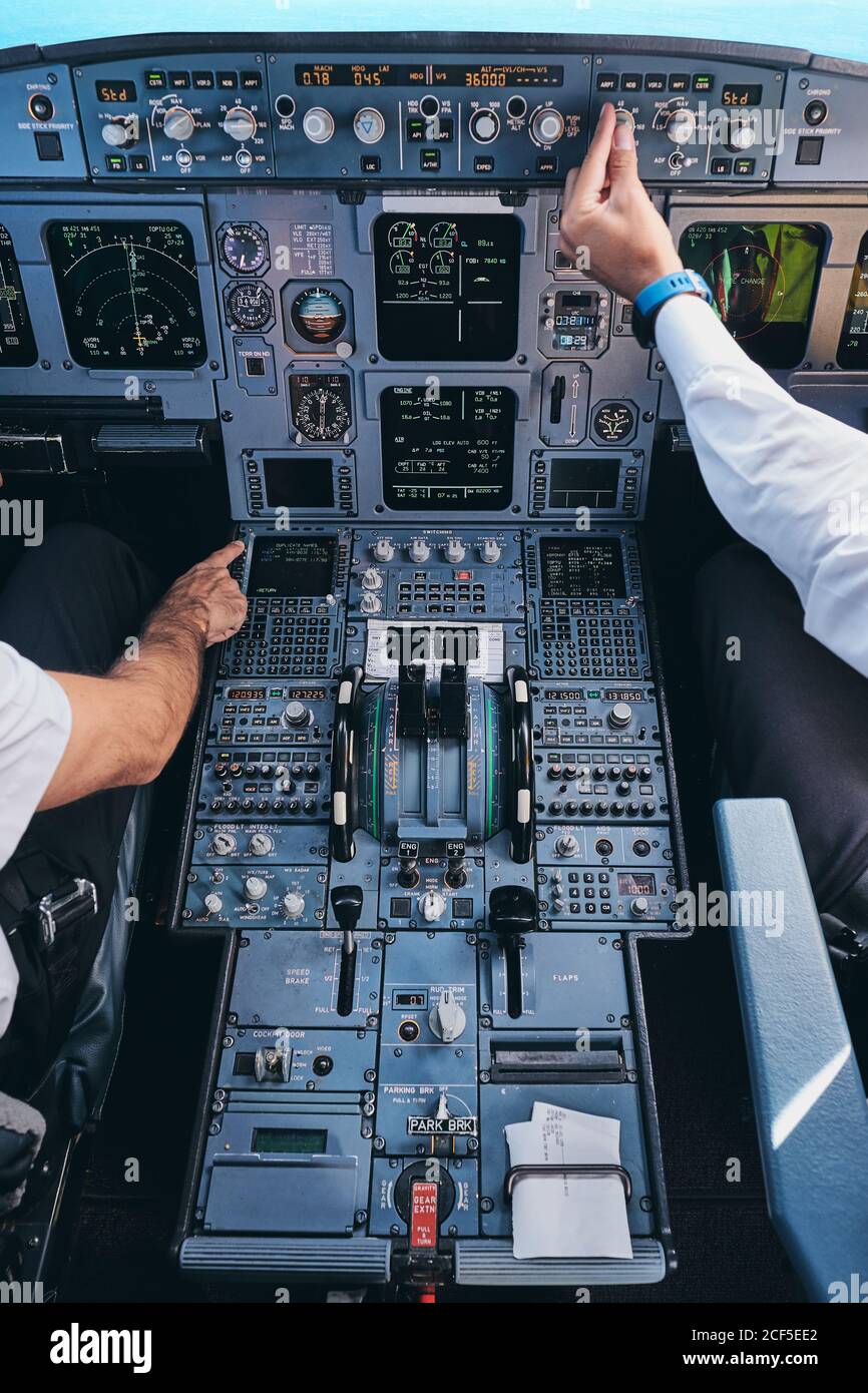 Pilots working in cockpit during flight Stock Photo - Alamy
