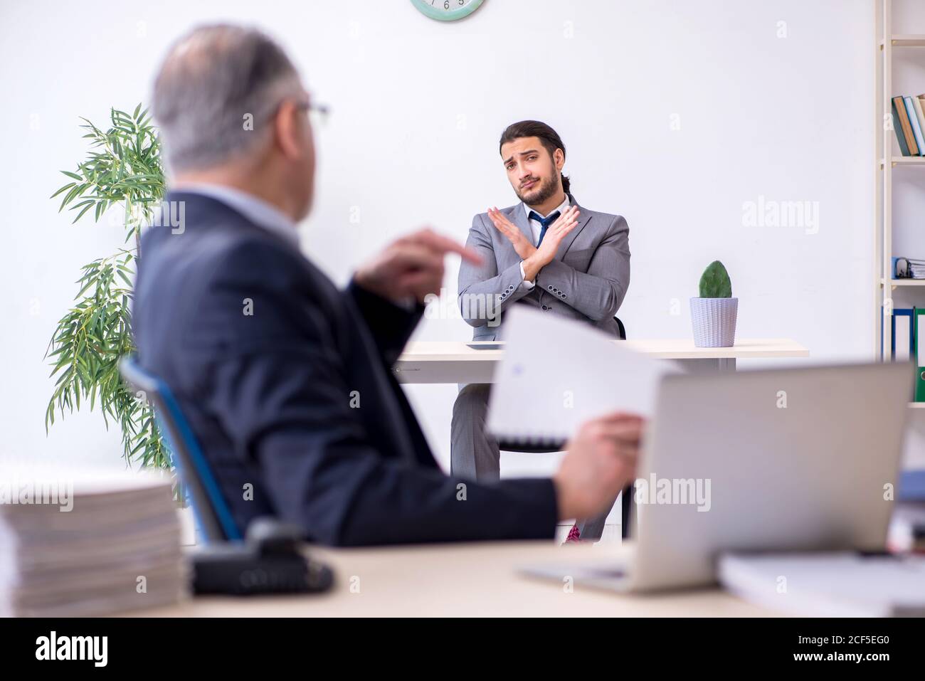 Old boss and his assistant working in the office Stock Photo - Alamy
