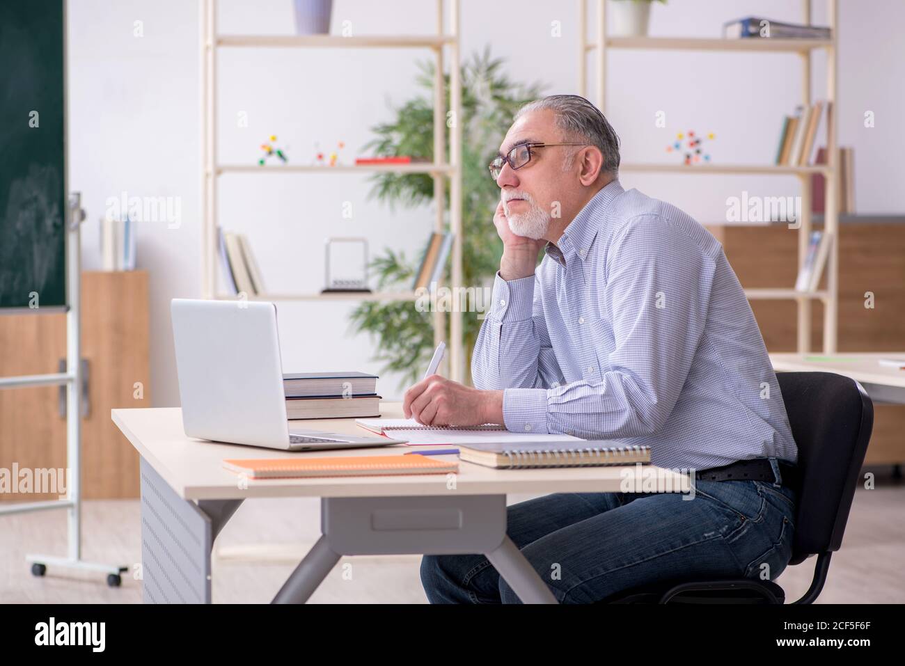 Old male teacher in the school classroom Stock Photo - Alamy
